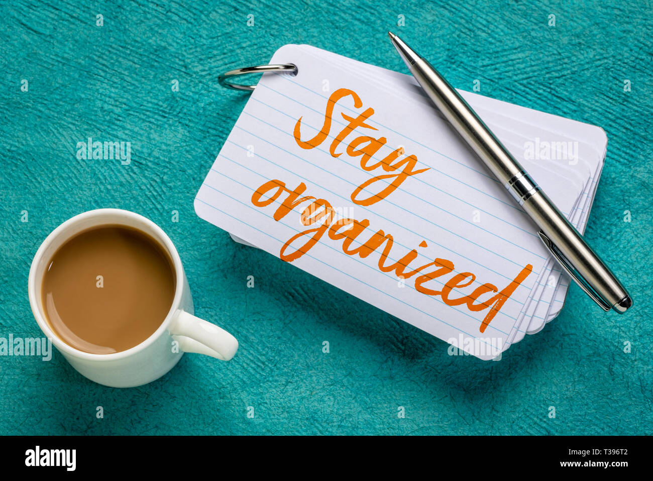 Stay organized - reminder on a stack of index cards with a cup of ...