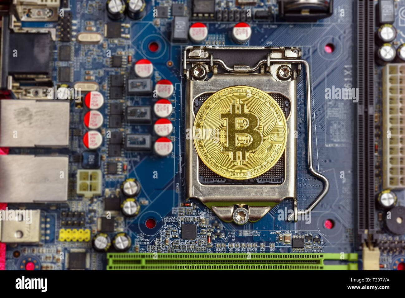Top view of golden bit coin on computer mother board processor.Bitcoin ...