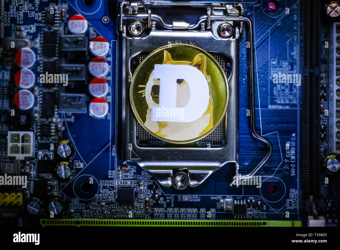 Top view of Dogecoin cryptocurrency physical coin on computer mother ...