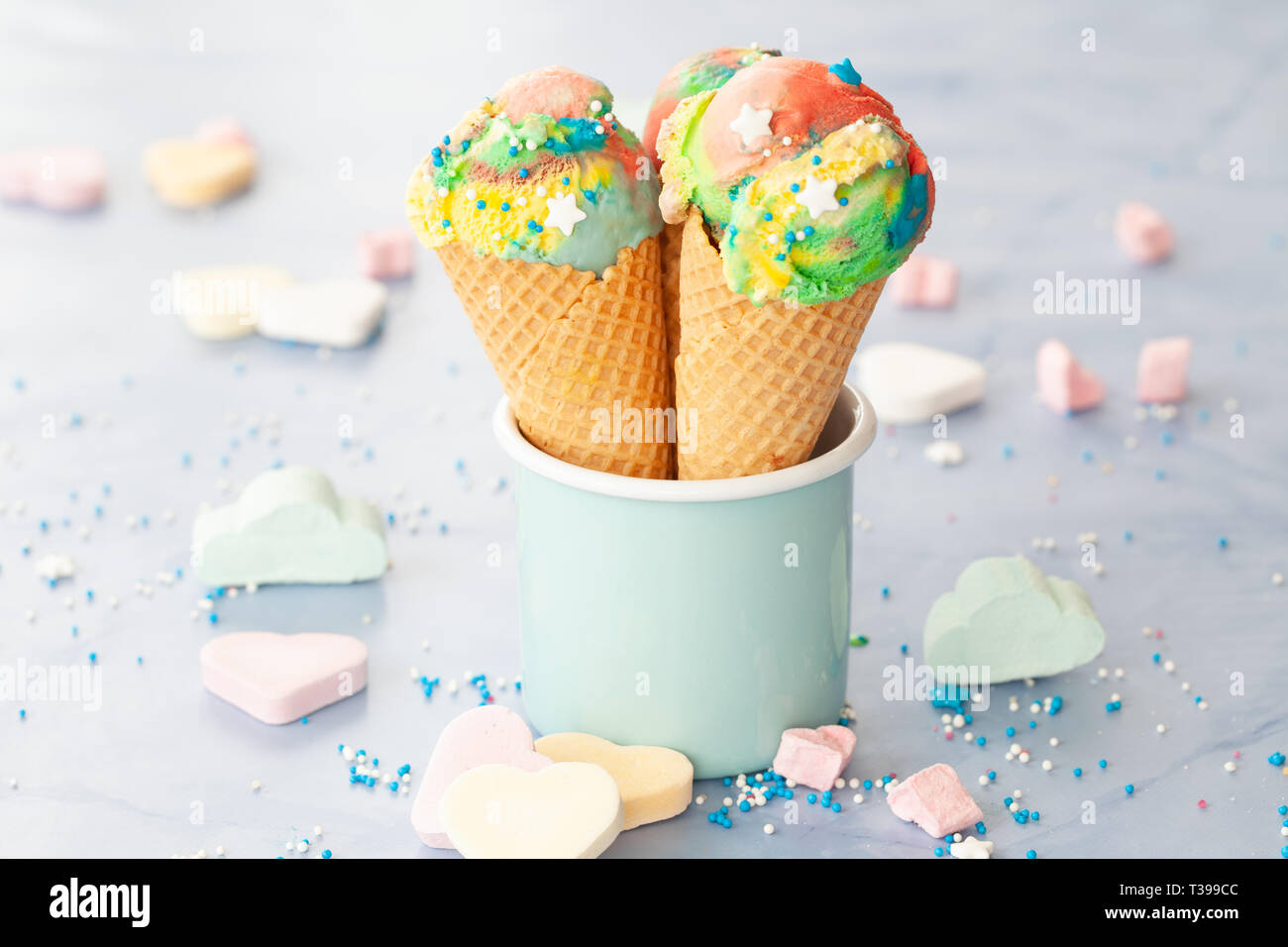 Ice cream cones in rainbow colors with colorful candy Stock Photo - Alamy