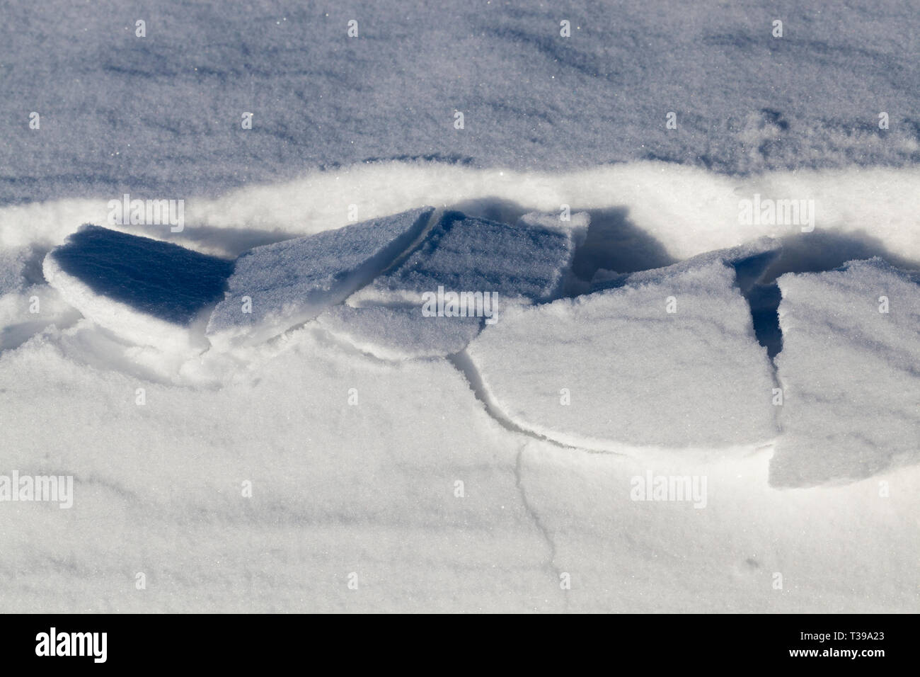 A large beautiful snowdrift of snow, part of which was destroyed under ...