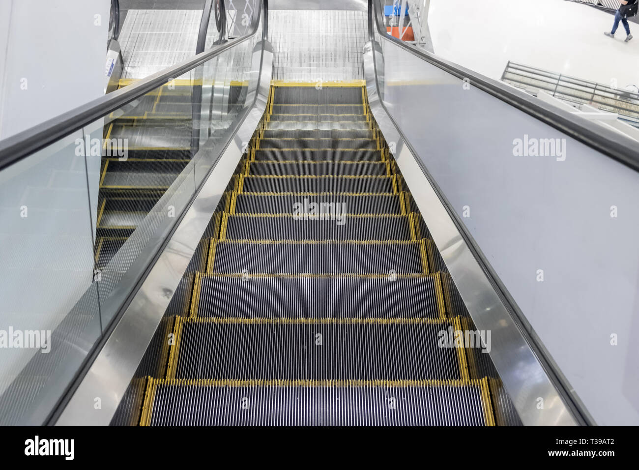 Escalator siding down in department store Stock Photo - Alamy