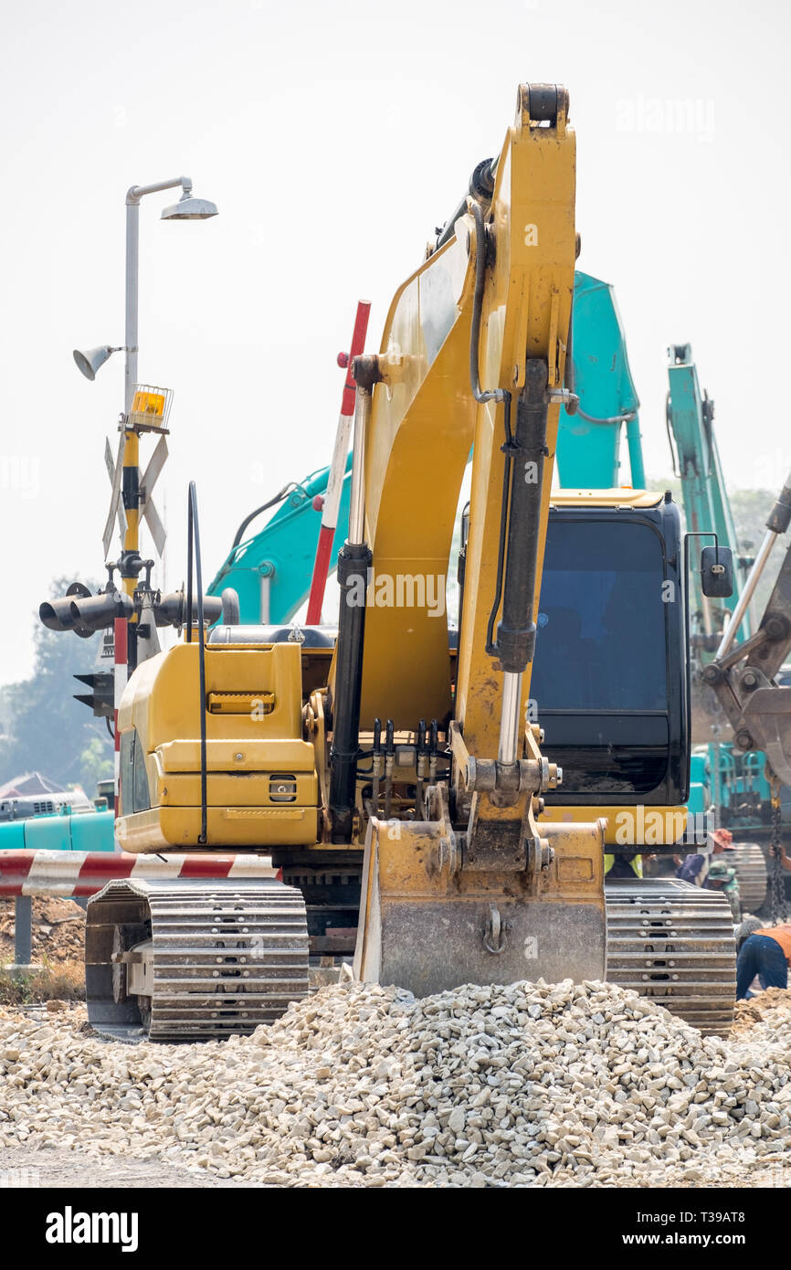 Backhoe and improvement construction of railway Stock Photo - Alamy