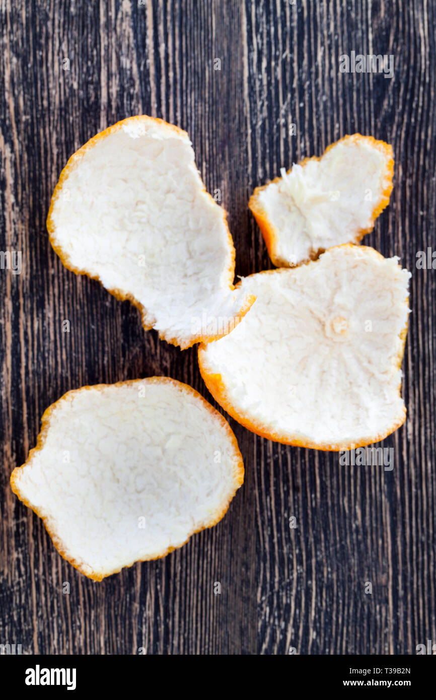 Purified yellow white rind of tangerines on a natural wooden surface in ...