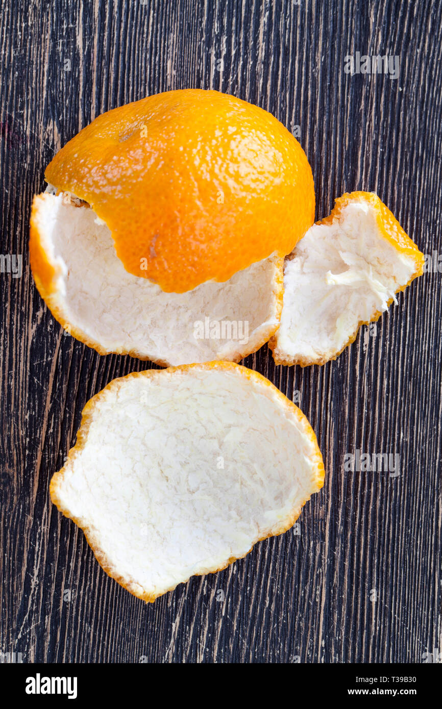 Purified yellow white rind of tangerines on a natural wooden surface in ...
