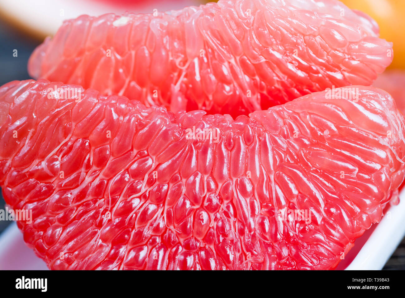 background of peeled red grapefruit , closeup of juicy citrus fruits ...