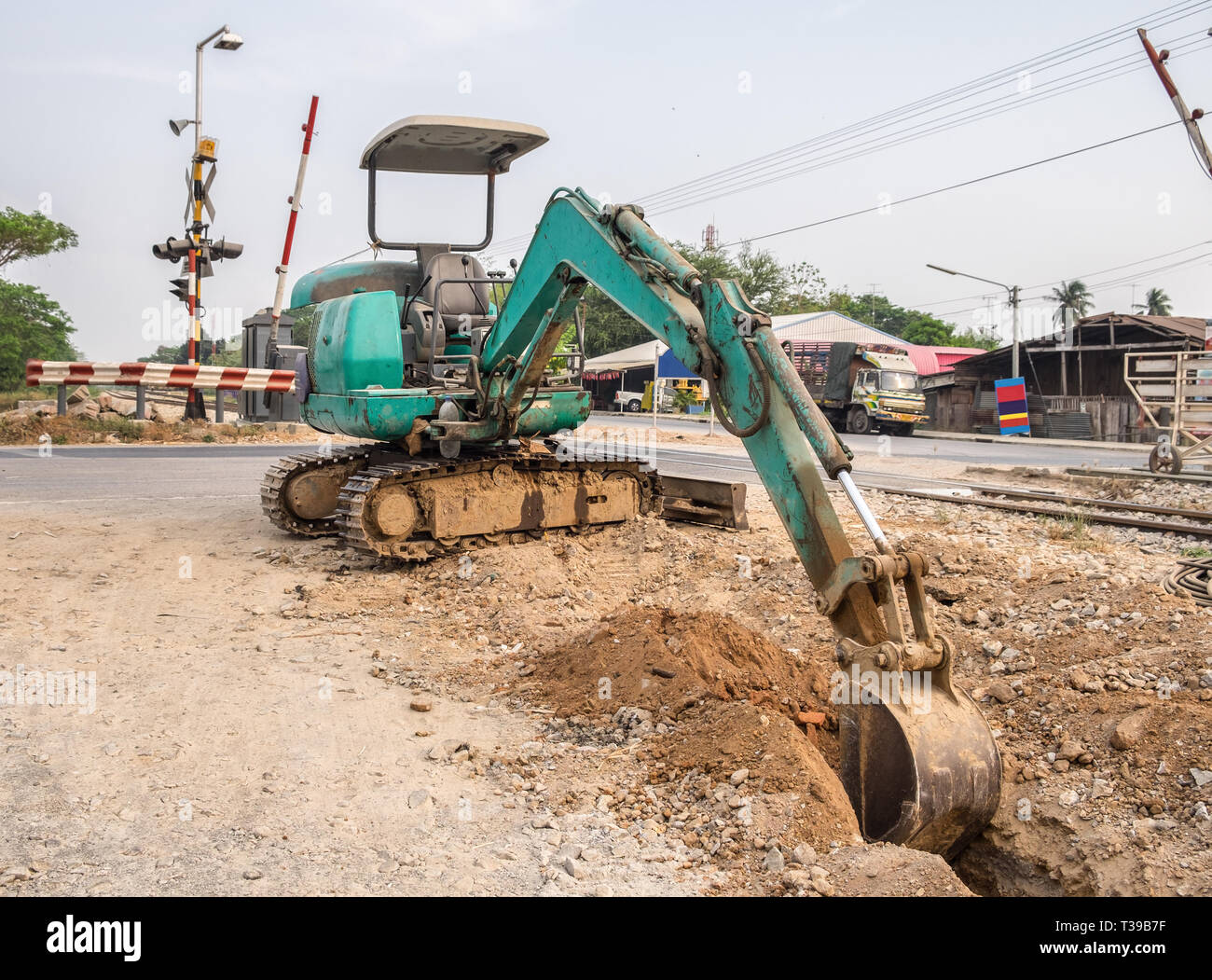 Green backhoe dredging soil earth Stock Photo - Alamy