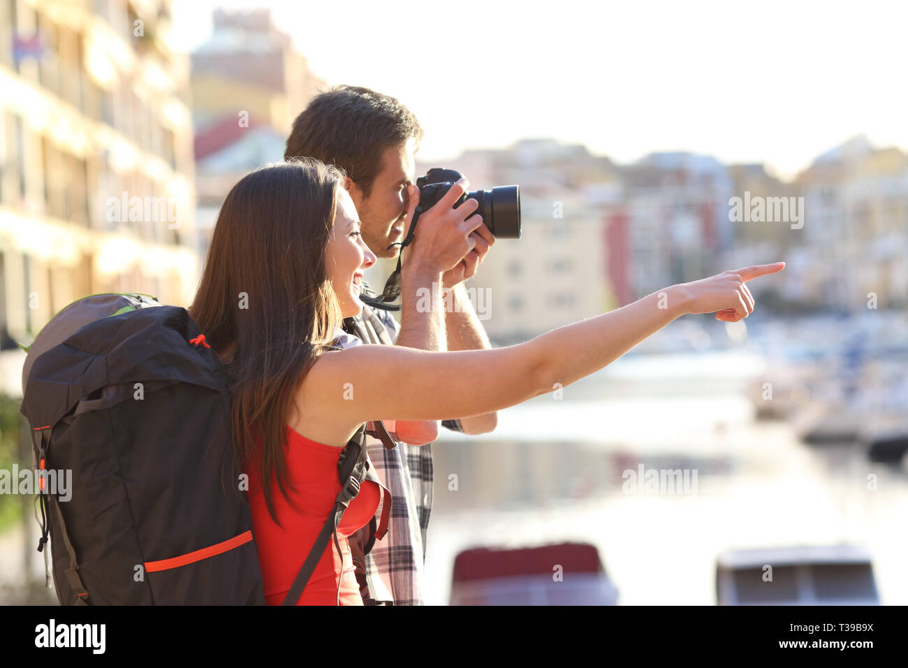 Two backpackers taking photos of landmarks on summer vacation Stock ...