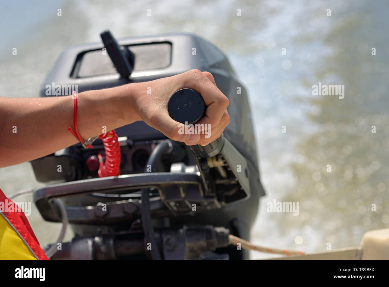 fisherman hand and speed boat engine Stock Photo - Alamy