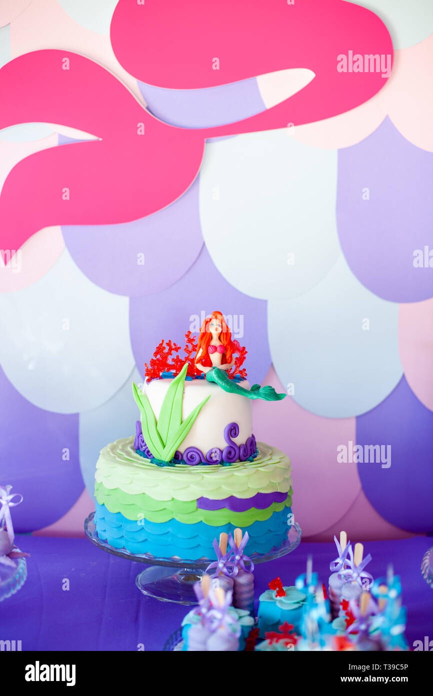 Mermaid theme cake with colorful glitter tails, shells and sea ...