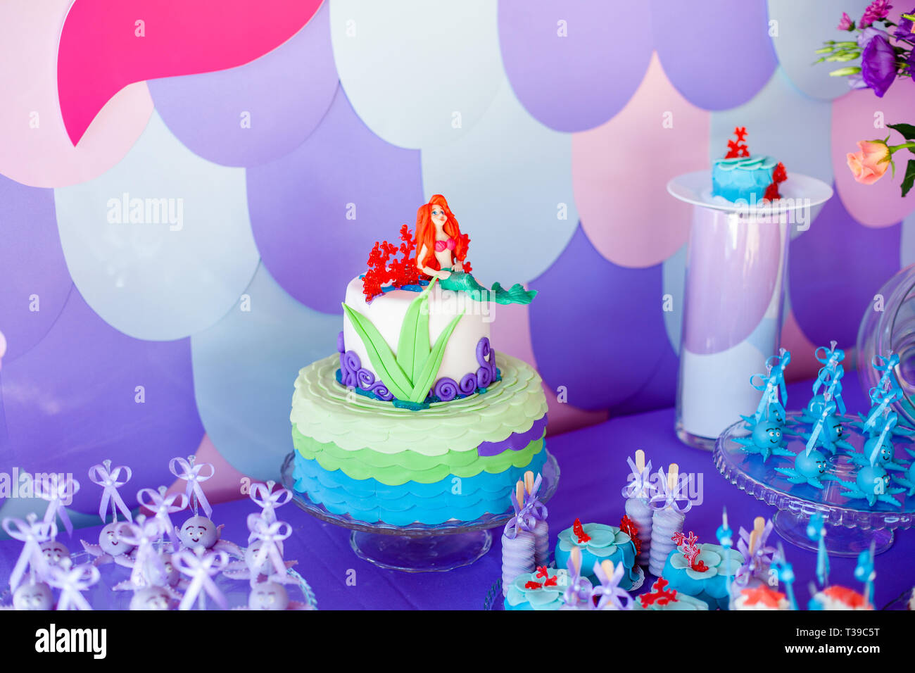 Mermaid theme cake with colorful glitter tails, shells and sea ...