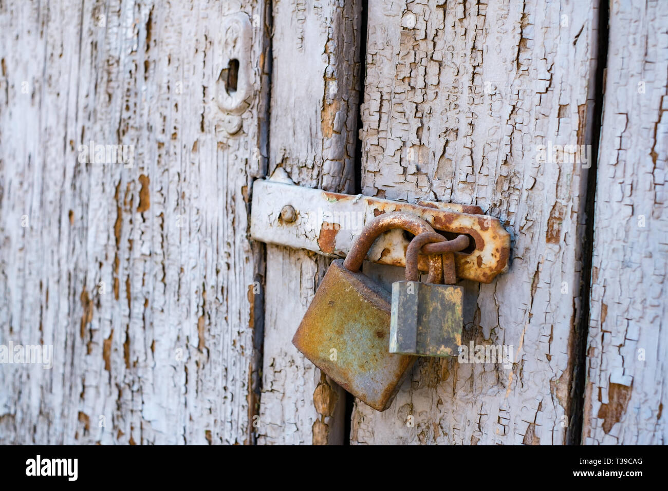 rusty old locks on an old wooden gate Stock Photo - Alamy