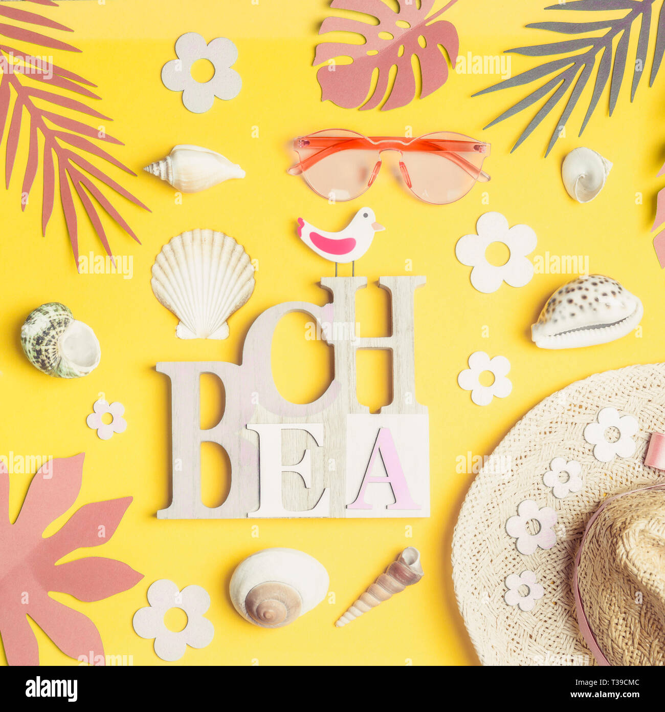 Word beach with straw hat , sunglasses, shells and tropical leaves on ...