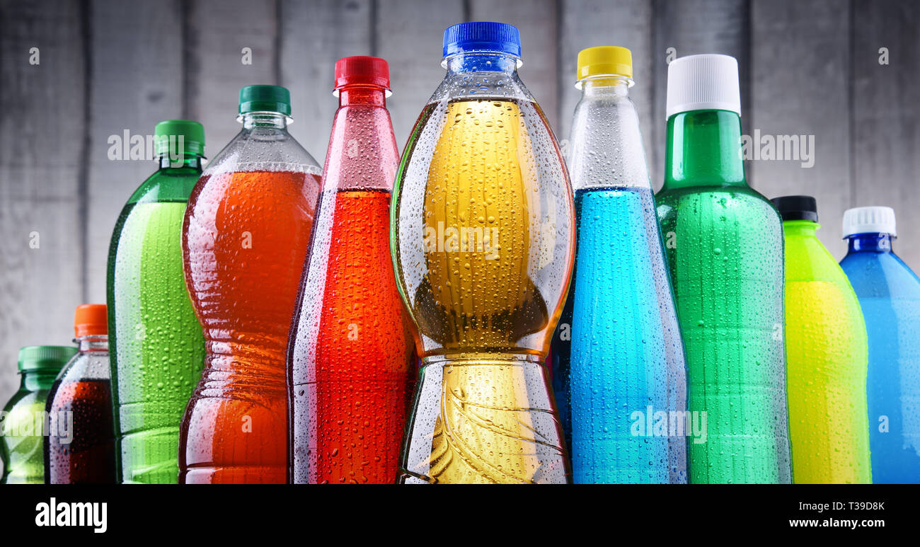 Plastic bottles of assorted carbonated soft drinks in variety of colors ...