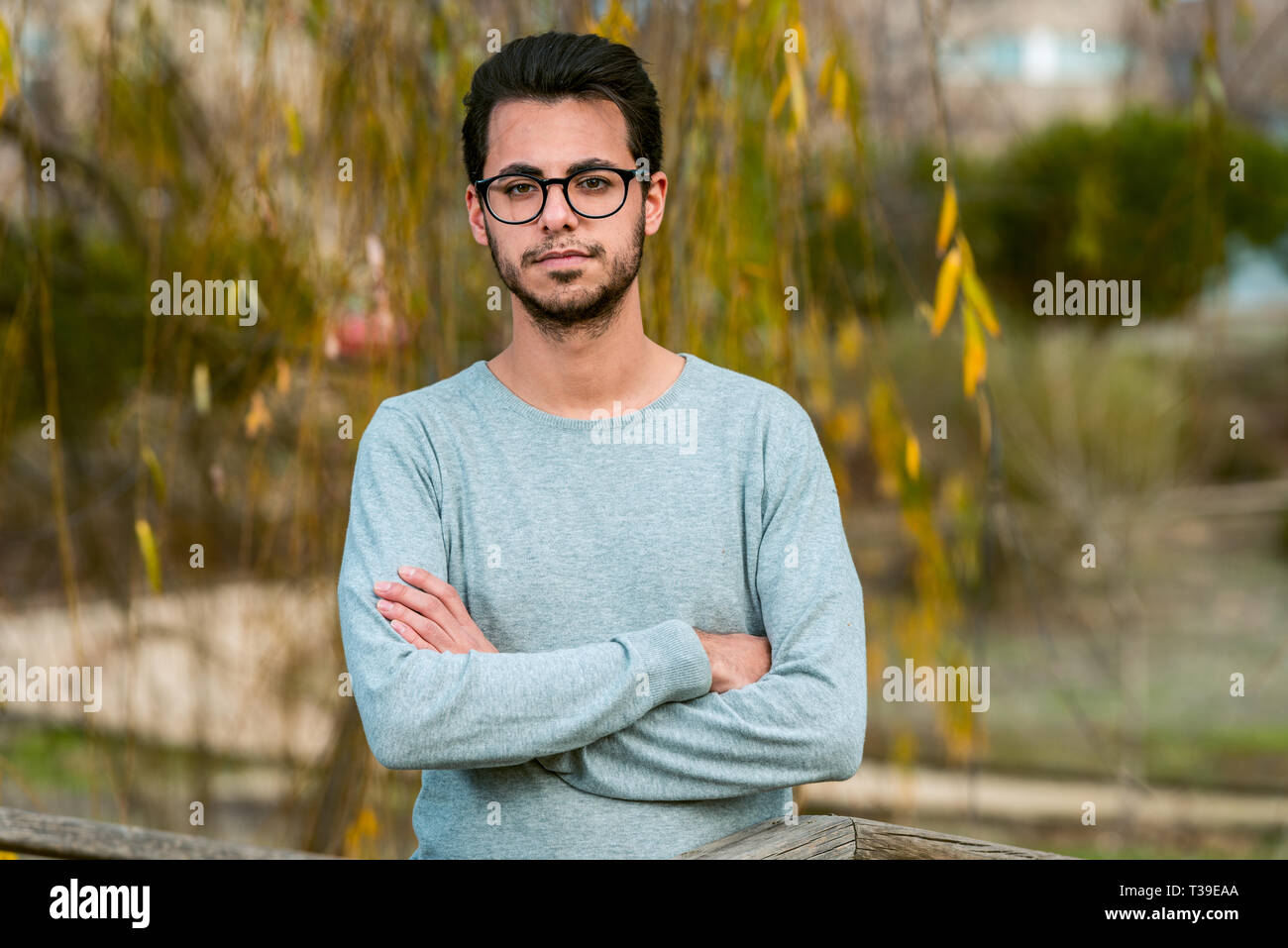 Young student of computer science poses at the campus park near the ...