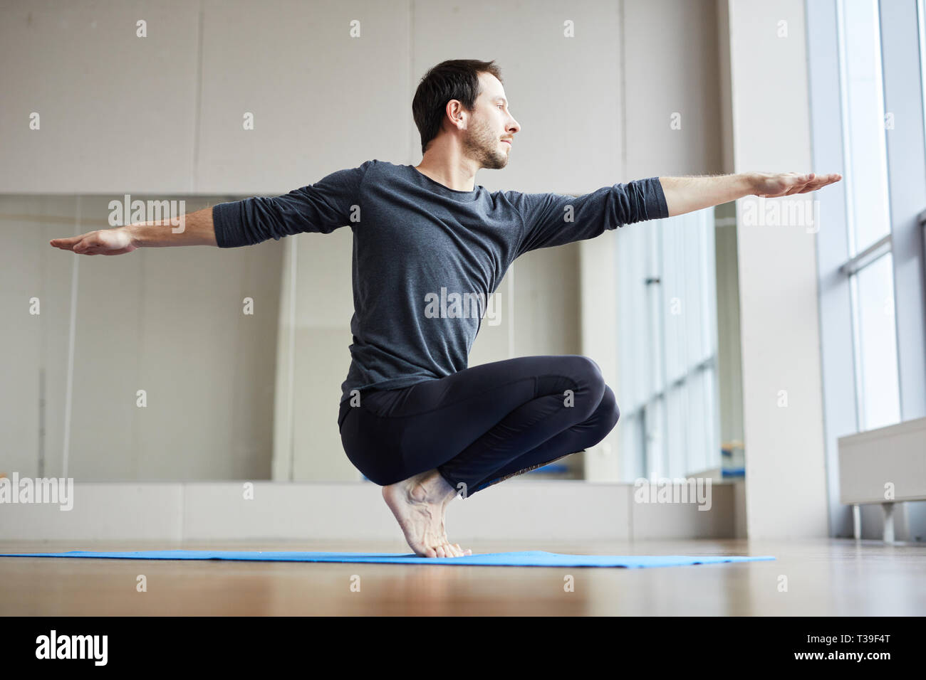 Man balancing on toes Stock Photo - Alamy