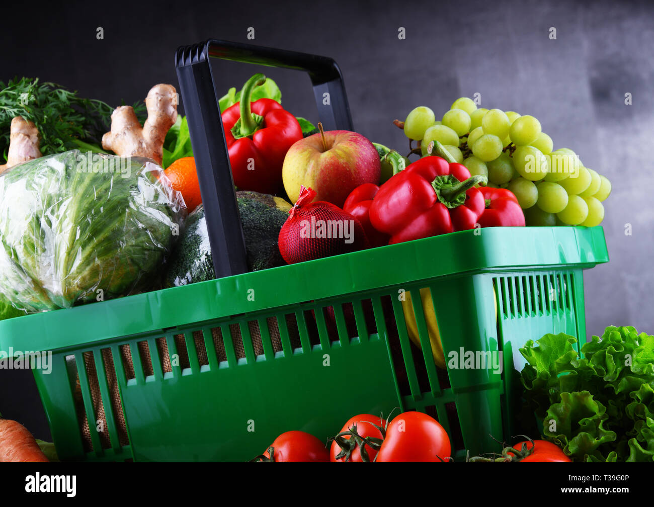 Fresh organic fruits and vegetables in plastic shopping basket Stock ...