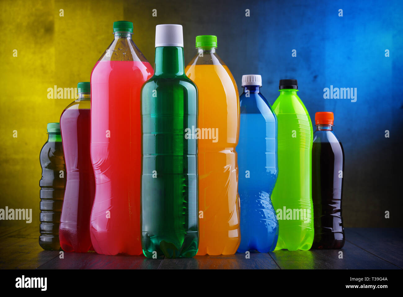 Plastic bottles of assorted carbonated soft drinks in variety of colors ...