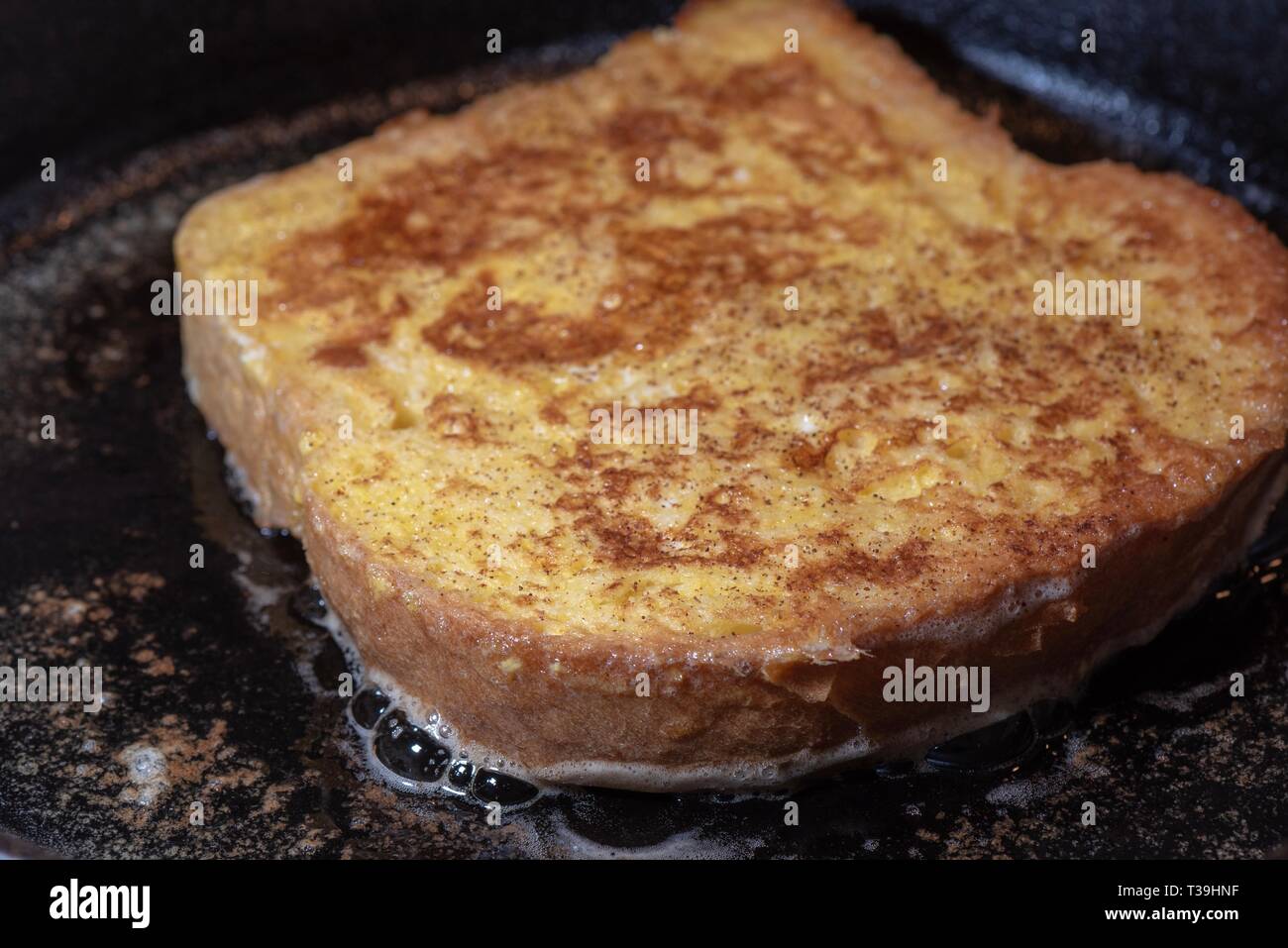 Making breakfast French toast in cast iron frying pan Stock Photo - Alamy