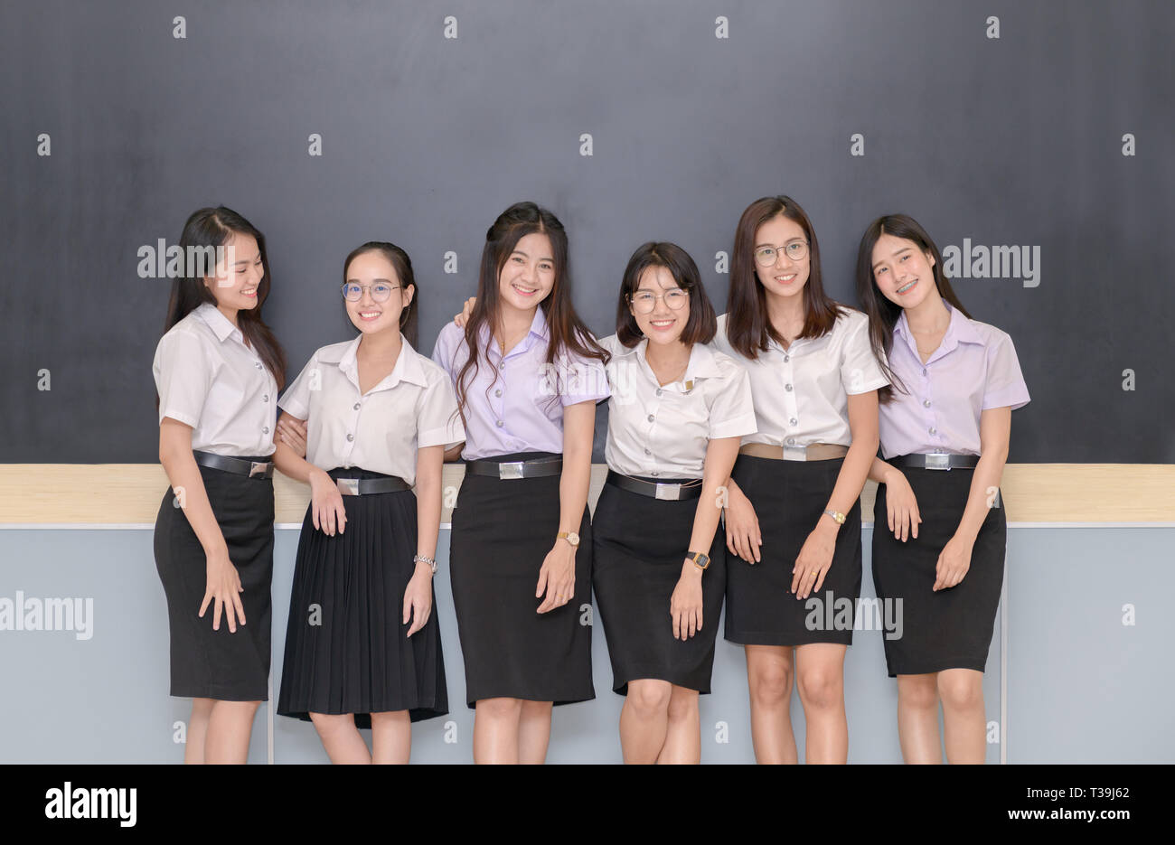 Happy teen students standing together in classroom, Education concept ...