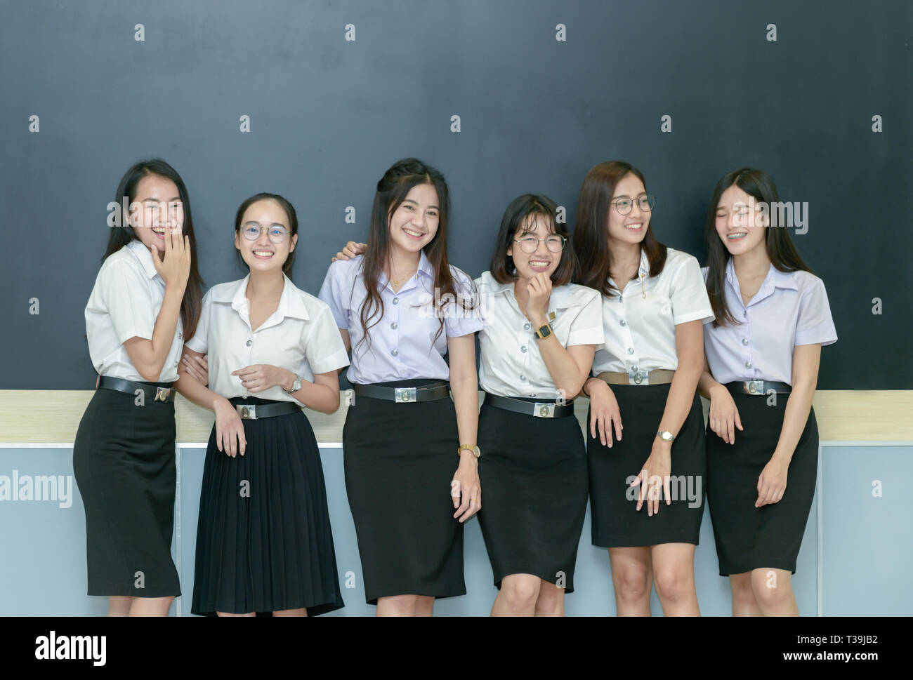 Happy teen students standing together in classroom, Education concept ...