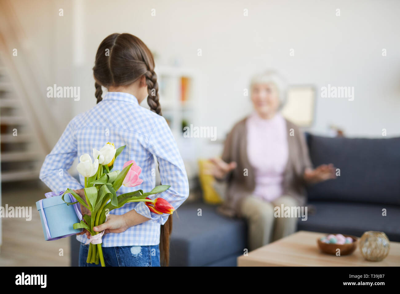 Girl Surprising Grandma Stock Photo - Alamy