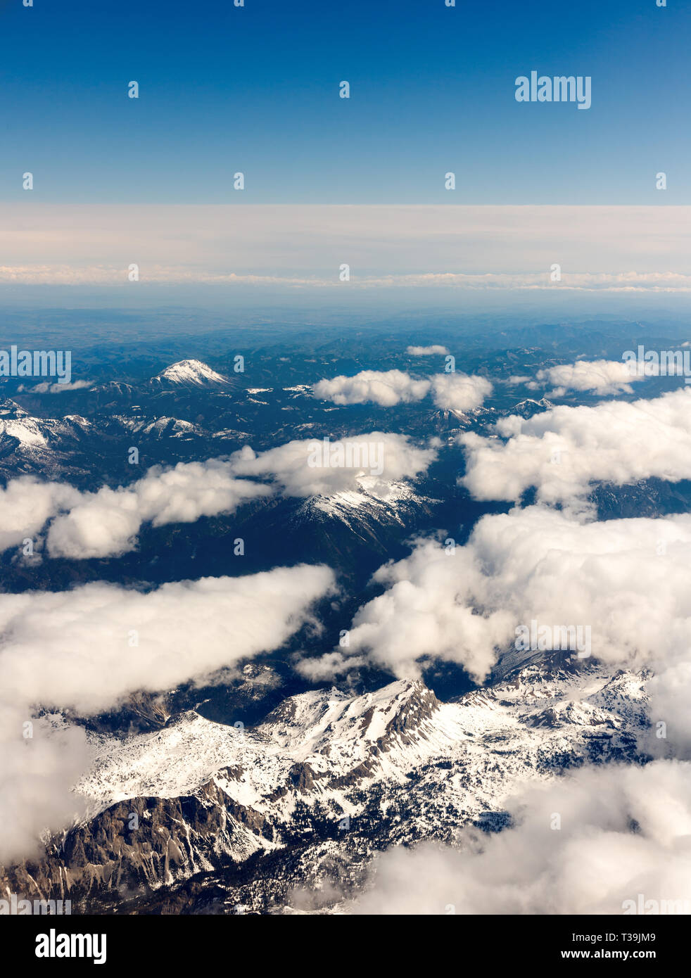 beautiful clouds from above with sow covered mountains Stock Photo - Alamy