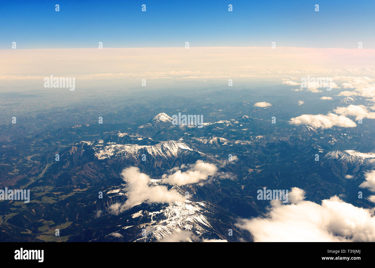 beautiful clouds from above with sow covered mountains Stock Photo - Alamy