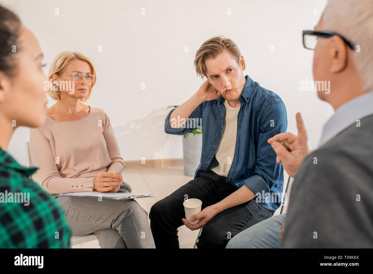 Listening to groupmate Stock Photo - Alamy