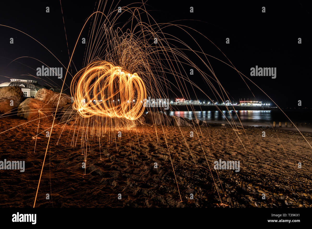 Steel wool spinning on the beach Stock Photo - Alamy