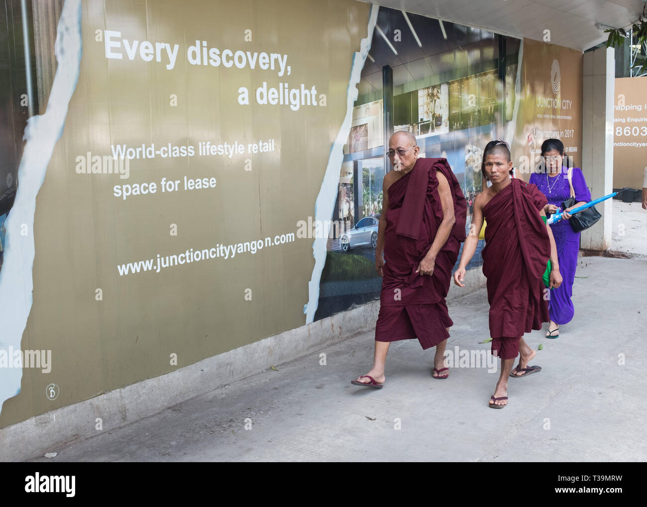 Monks walking past an advertising billboard in Yangon, Myanmar (Burma ...