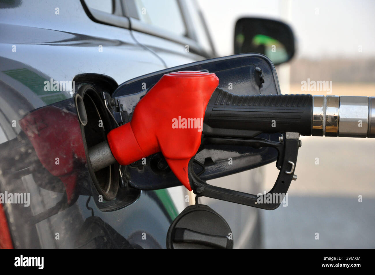 Fill the car with fuel. Refueling gun in tank filler Stock Photo - Alamy