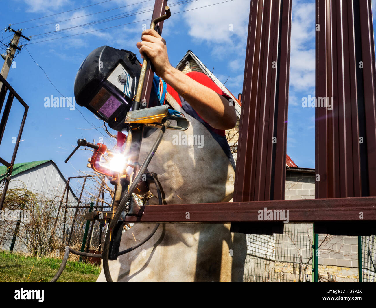 Man is welded to a steel gate metal latch Stock Photo - Alamy