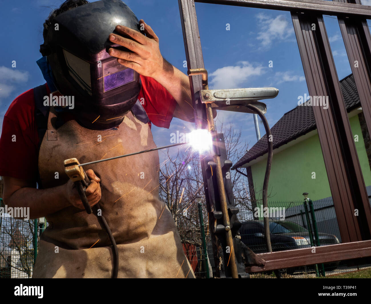 Man is welded to a steel gate metal latch Stock Photo - Alamy