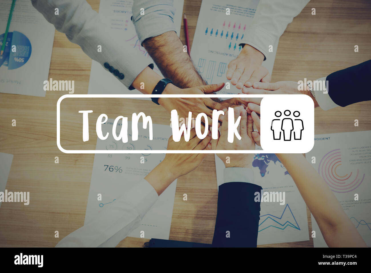 Multi-ethnic group of business people with hands together on desk ...