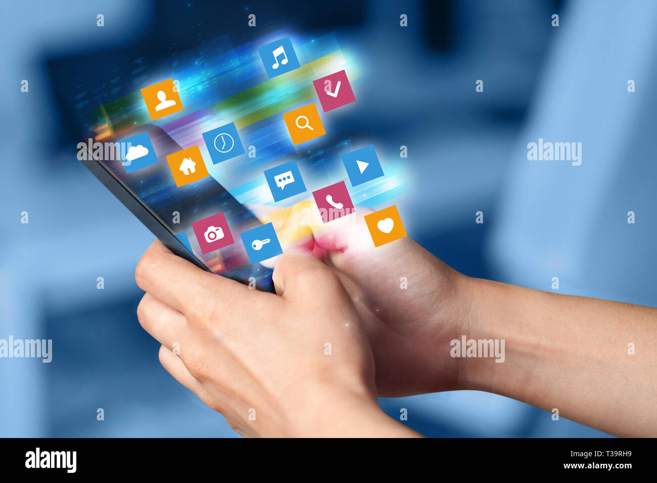 Hand using phone with colorful fast moving application icons and ...