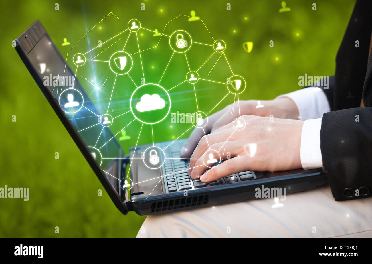 Hand using laptop with centralized cloud computing system and network ...
