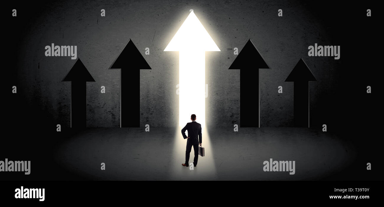 Young businessman with back choosing the best way Stock Photo - Alamy