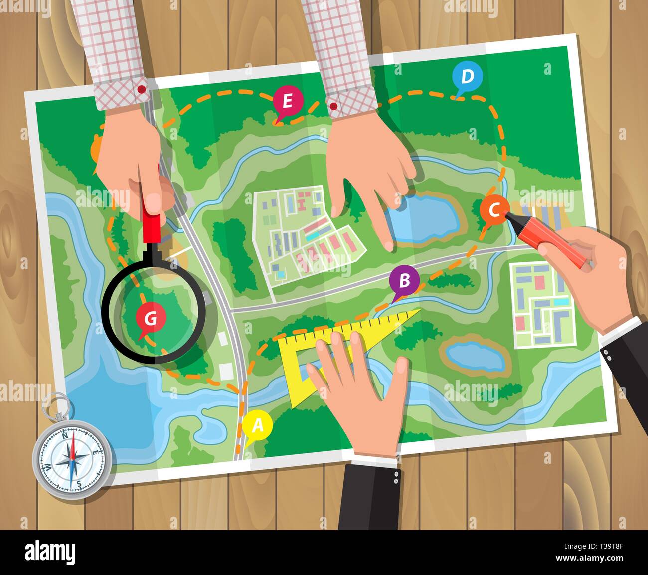 Wooden table with paper map and compass. Marker and magnifying glass in ...
