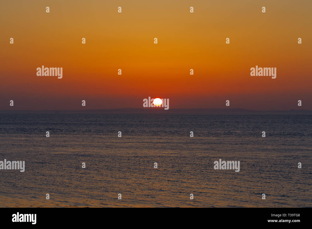 The sun about to set over the horizon Stock Photo - Alamy