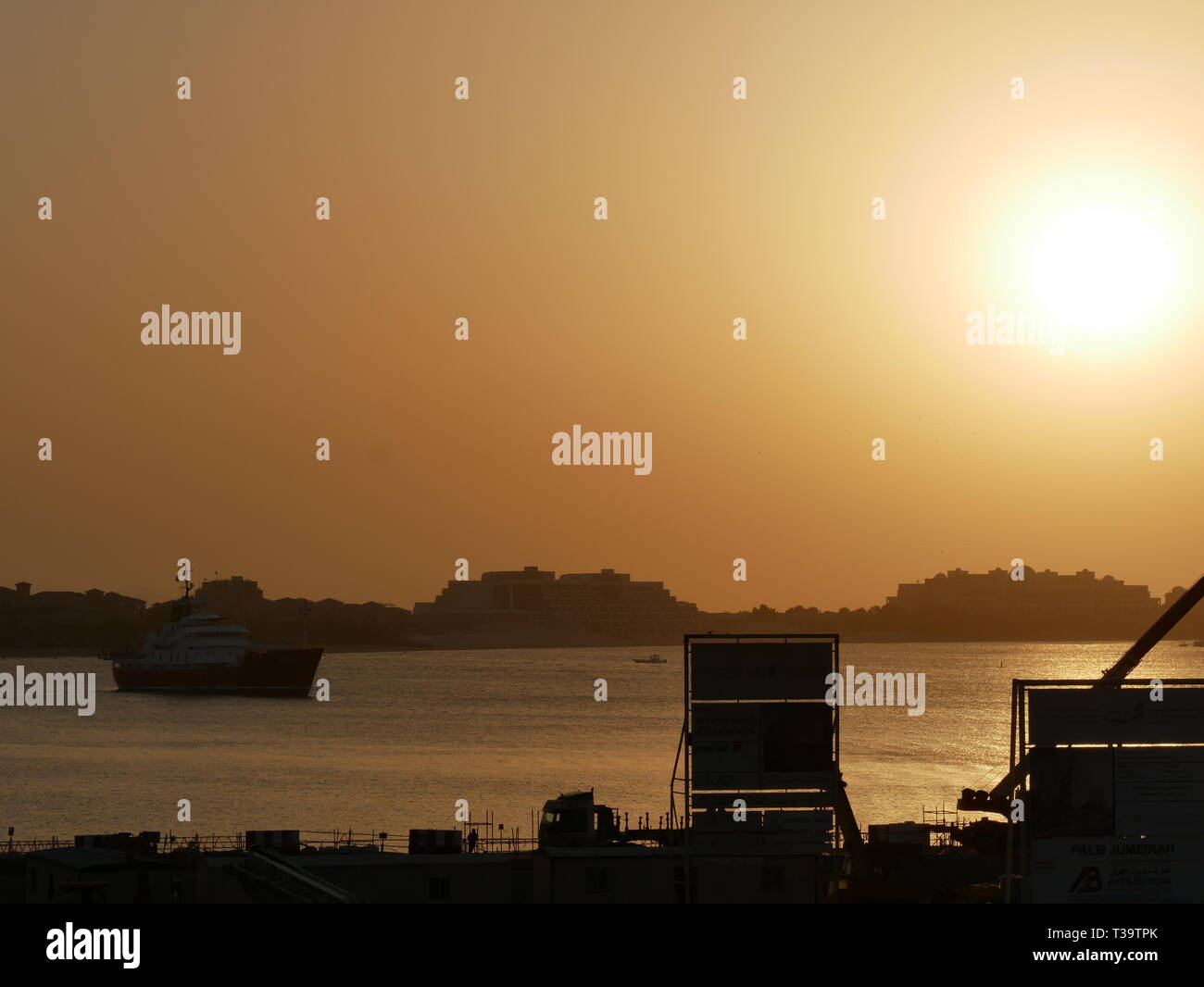 Sunset with container ship Stock Photo - Alamy