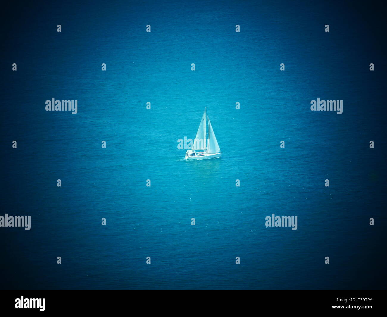 Lonly boat through telescope Stock Photo - Alamy