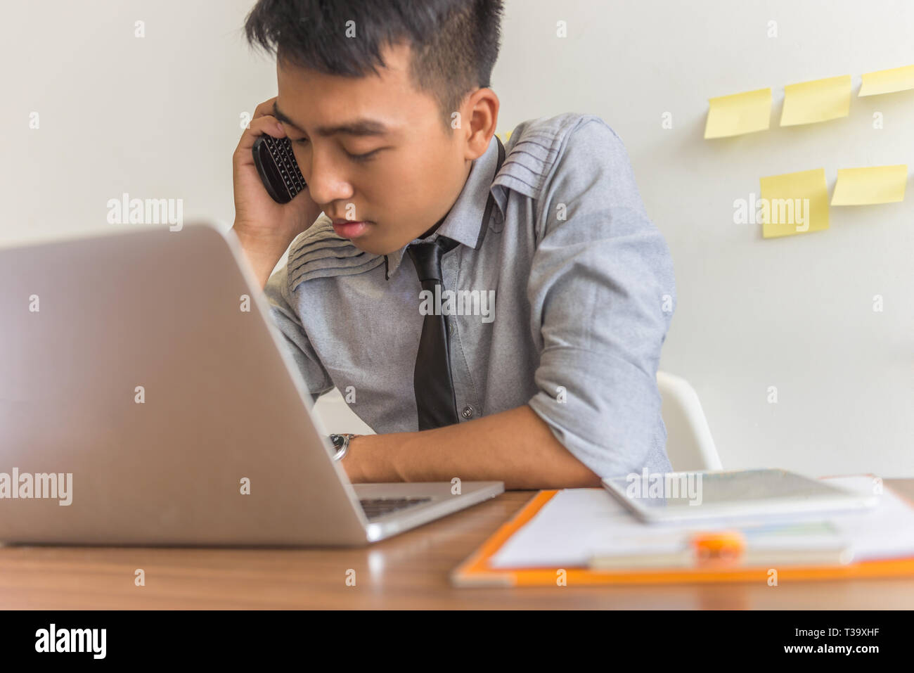 Young office man answering the phone call Stock Photo - Alamy