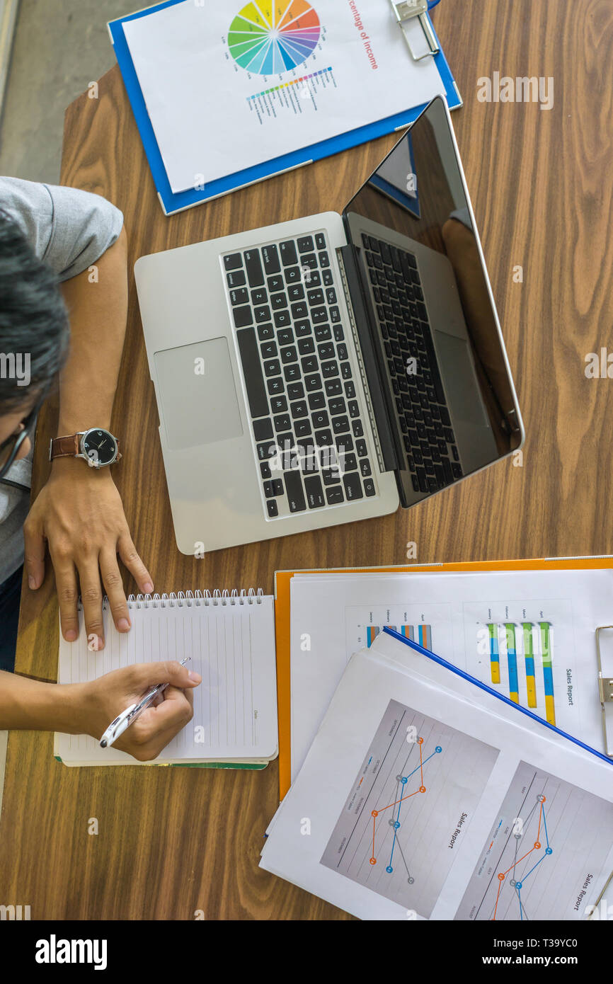 Vertical photo of businessman hand writing notes in office Stock Photo ...