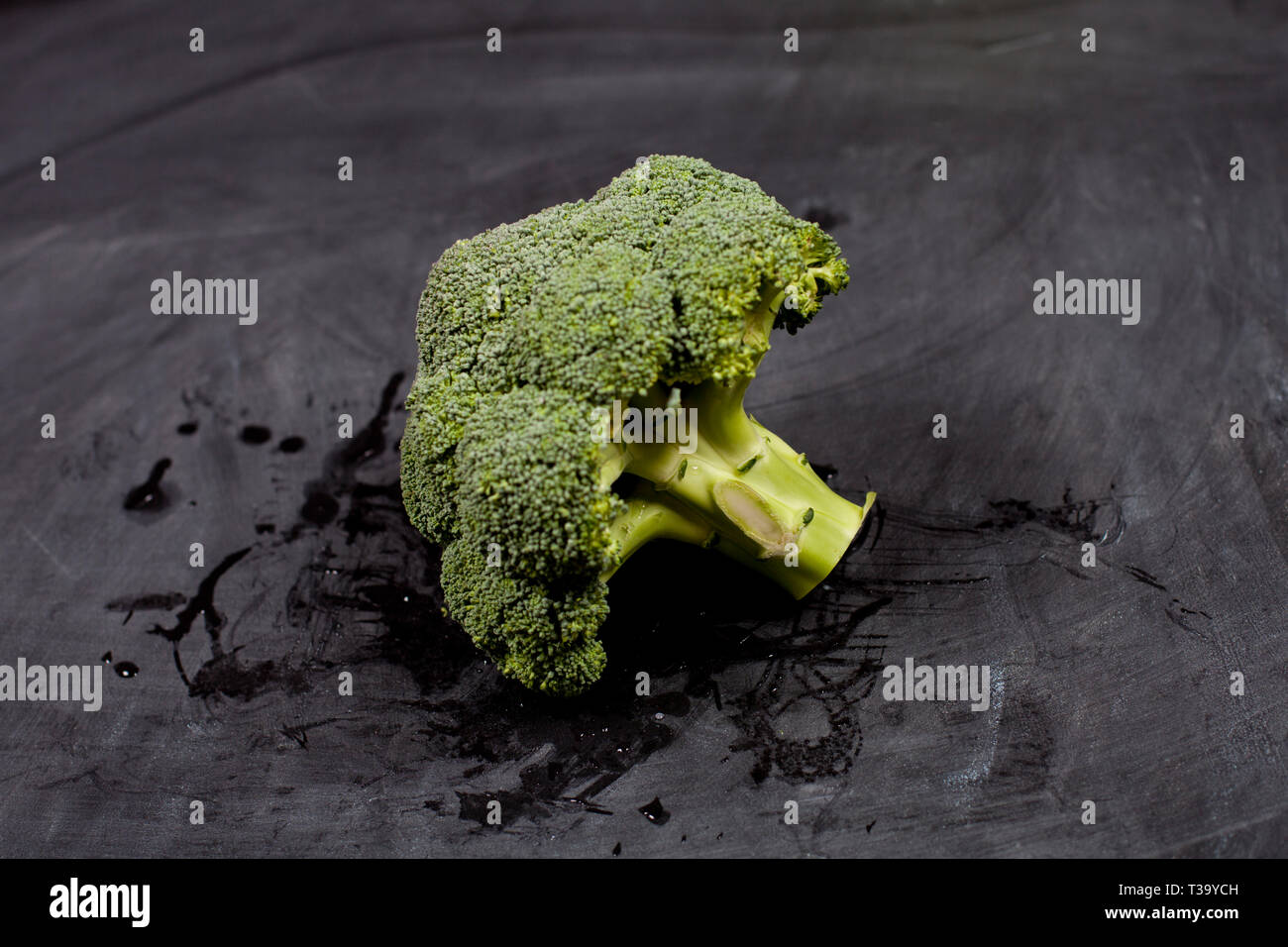 Fresh green wet organic broccoli on black background Stock Photo - Alamy