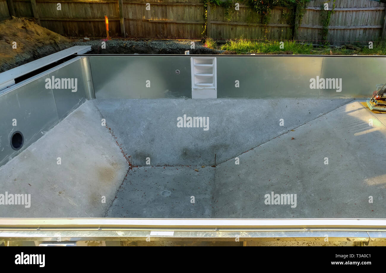 Installation metal pool in the ground at house backyard Stock Photo - Alamy