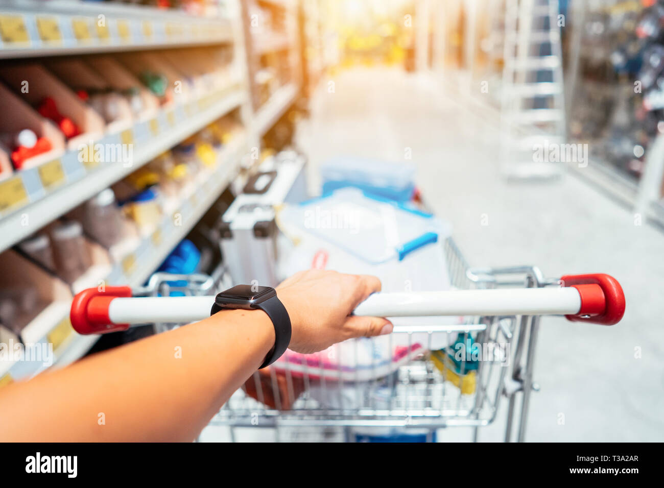 Human Hand Close Up With Shopping Cart in a Supermarket Walking Trough ...