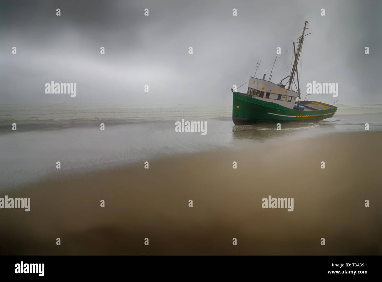 A fishing boat washed ashore Stock Photo - Alamy