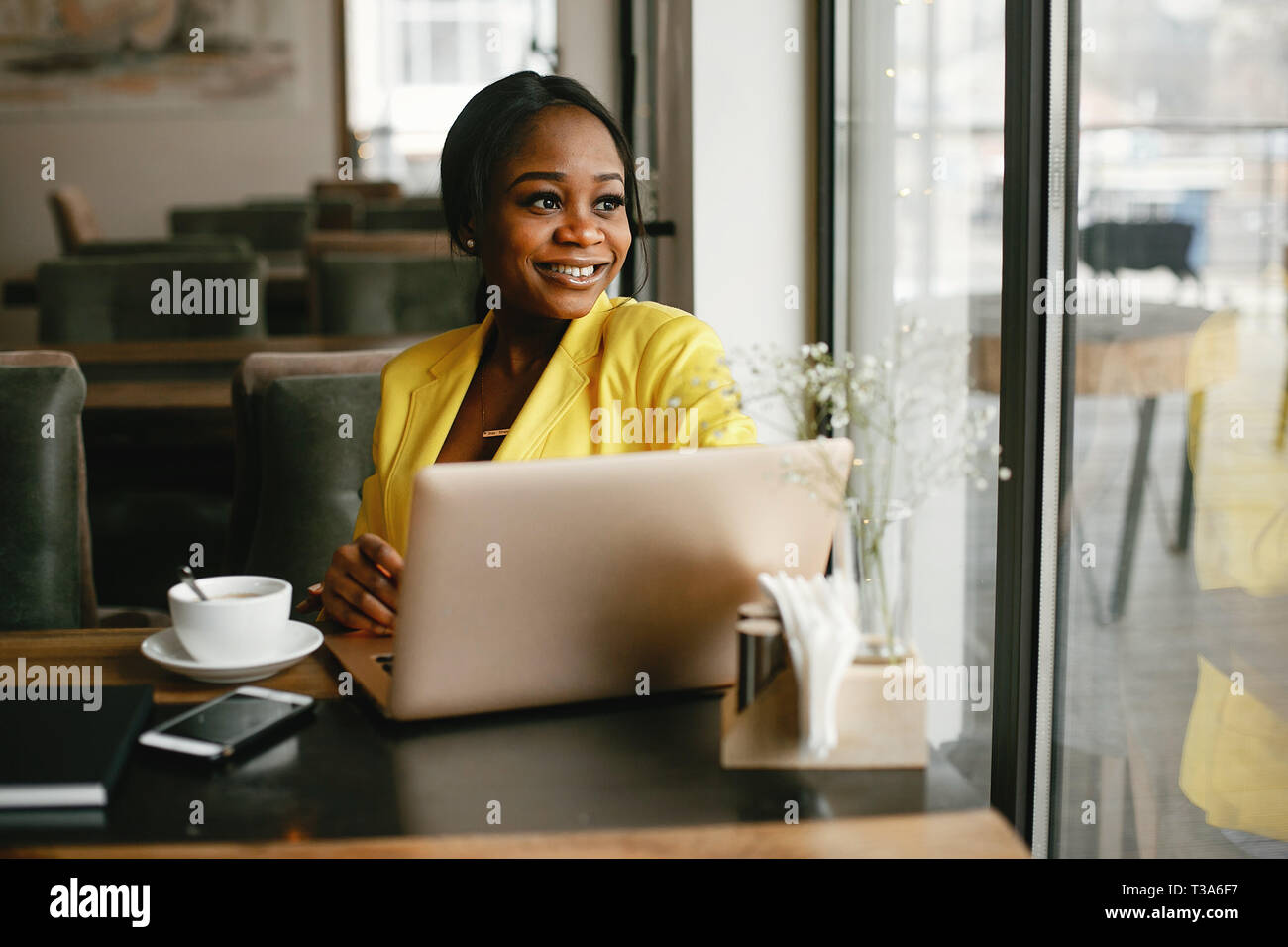 Elegant black woman. Lady in a yellow jacket. Businesswoman working in ...
