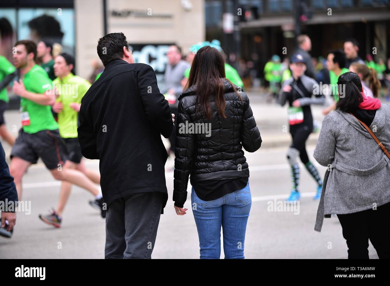 Chicago, Illinois, USA. A group of runners passing by spectators along ...